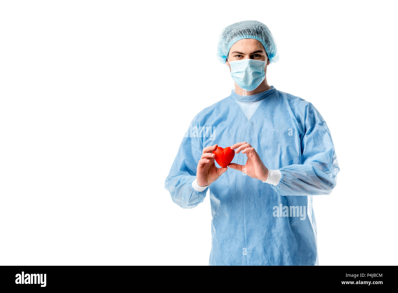 Cardiologist wearing blue uniform and holding toy heart isolated on ...