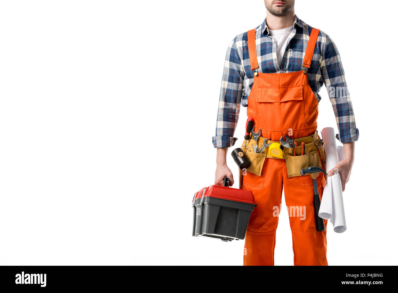 Cropped view of man in orange overall holding tool box and blueprint ...