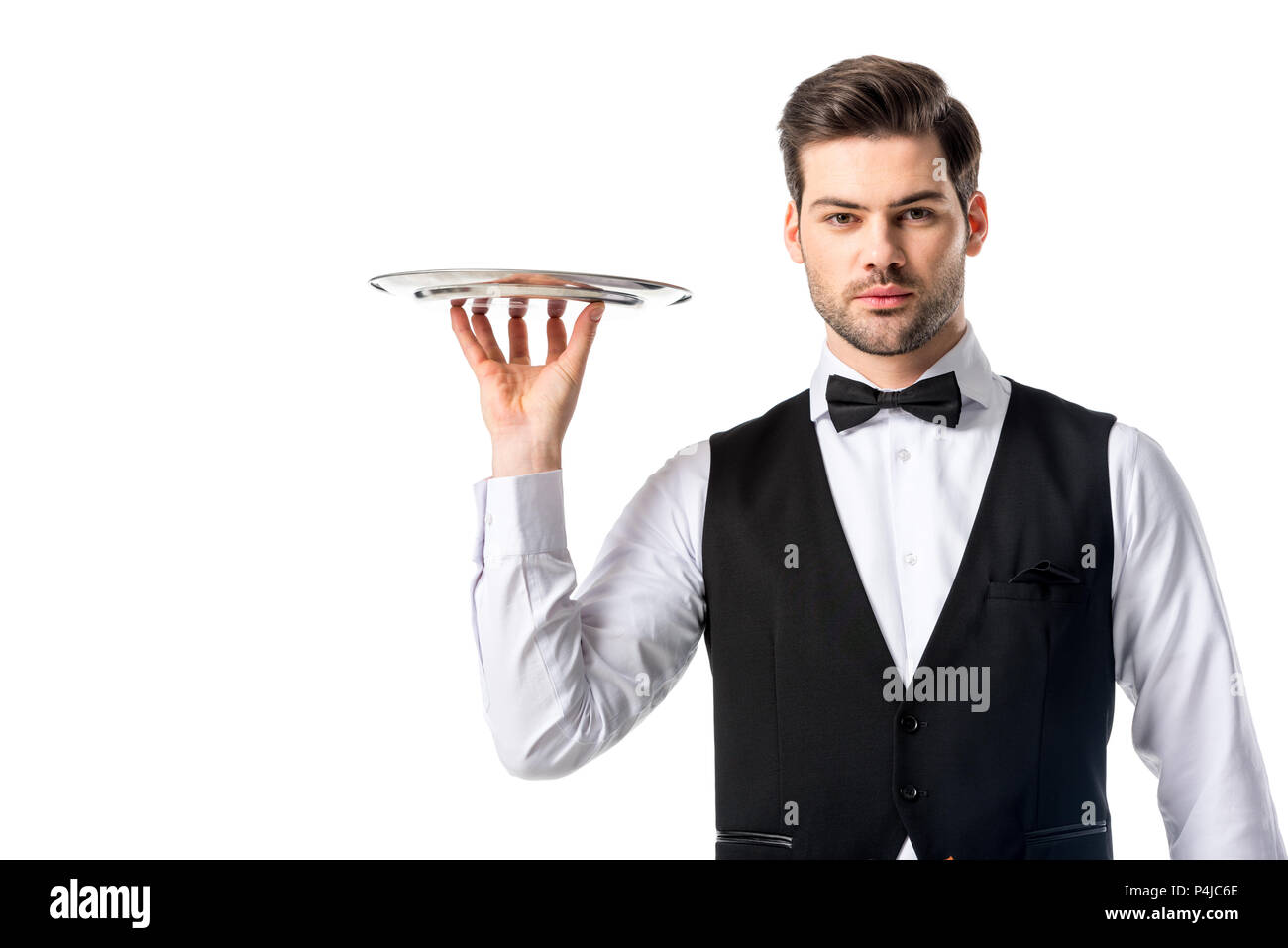 portrait of handsome waiter in suit vest with empty serving tray ...