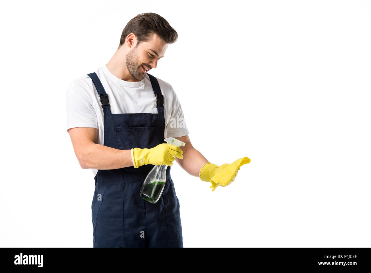 portrait of smiling cleaner in rubber gloves with detergent and rag ...