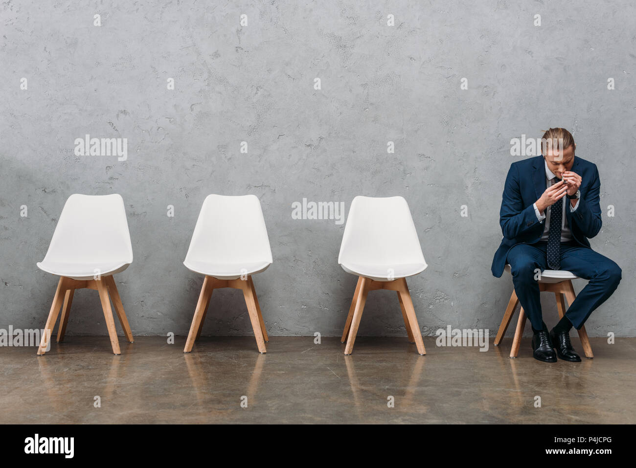 lonely businessman with drug addiction sniffing cocaine while sitting ...