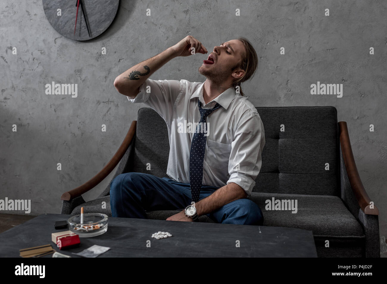 businessman with drug addiction taking mdma pill Stock Photo - Alamy