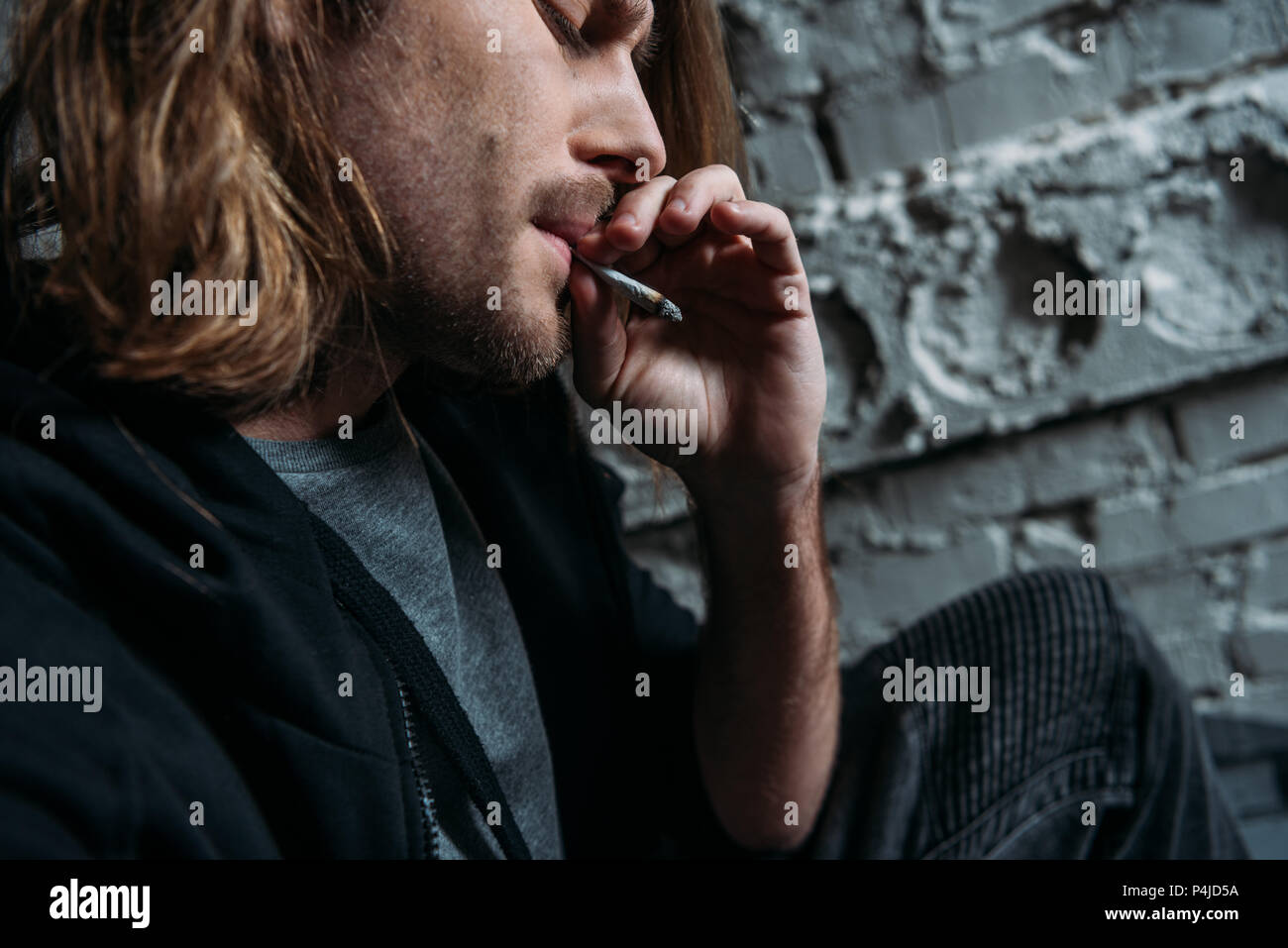 close-up shot of young man smoking cigarette Stock Photo - Alamy