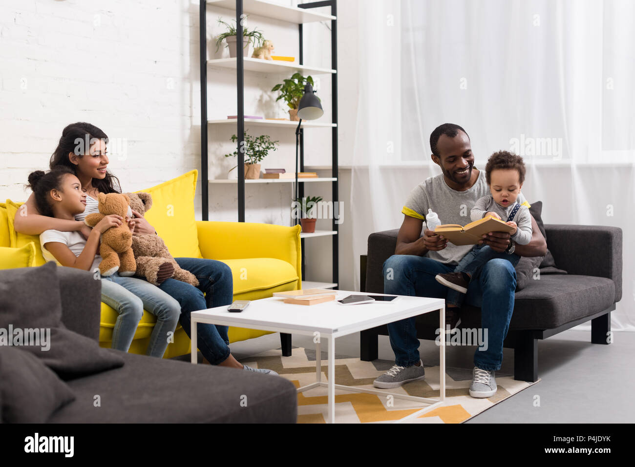 happy young parents spending time with kids at home Stock Photo - Alamy