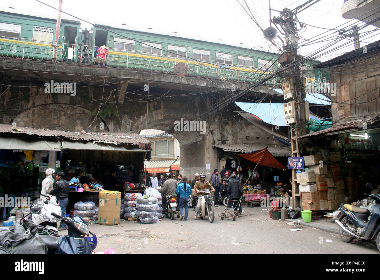 Train crossing over bridge above busy street, Hanoi, Vietnam Stock ...