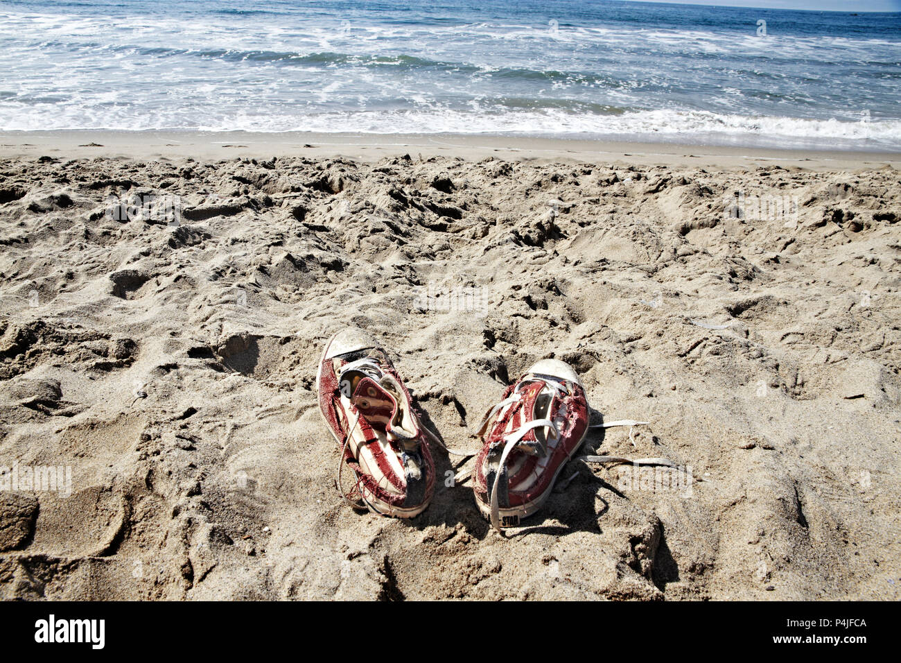 Forgotten shoes on the beach Stock Photo - Alamy