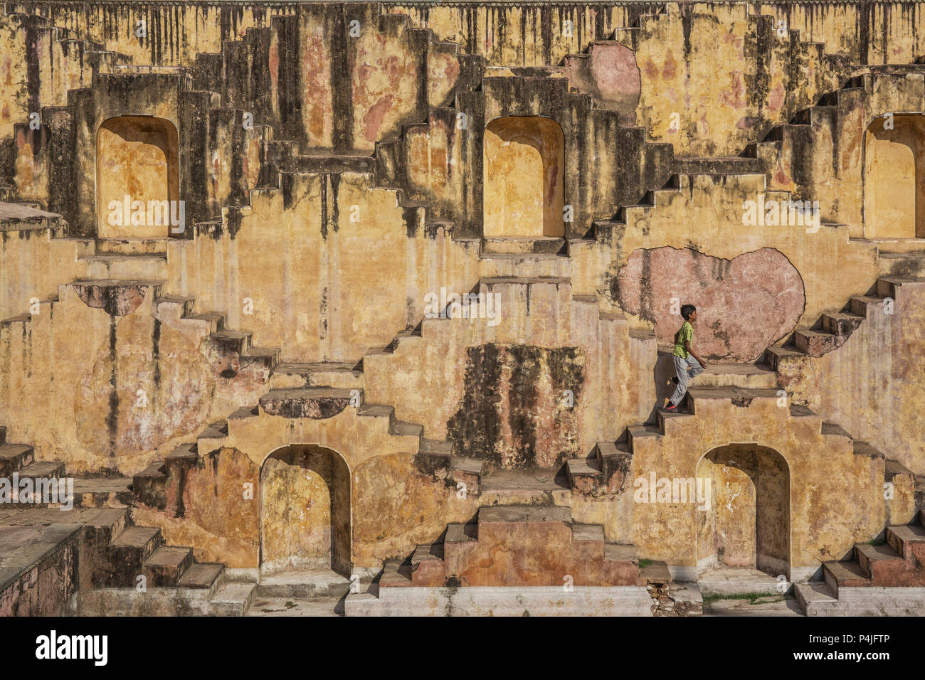 Local boy runs in the Step Well - Toorji Ka Jhalara. Local sight ...