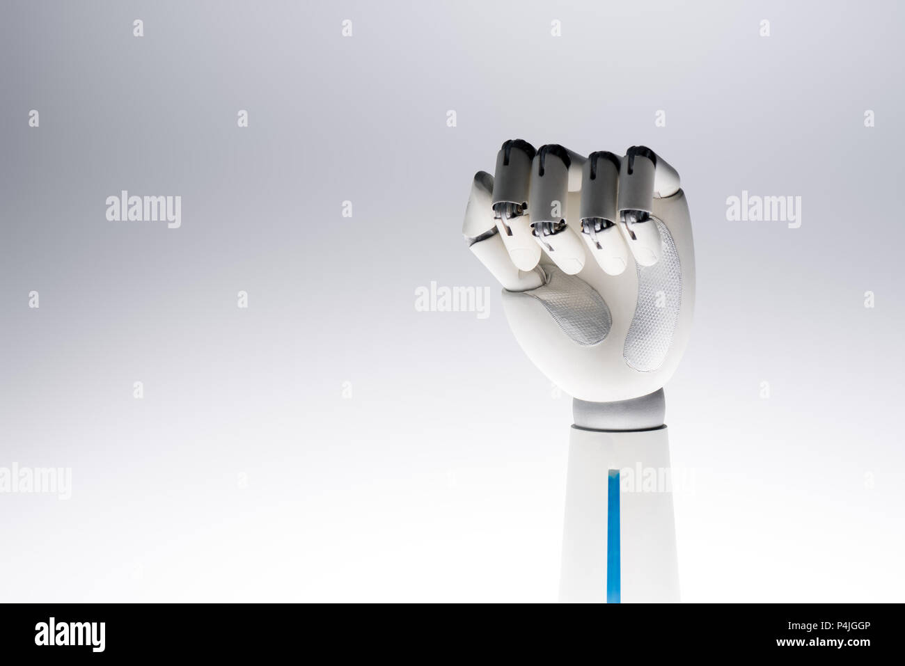 robot hand showing fist isolated on grey Stock Photo - Alamy