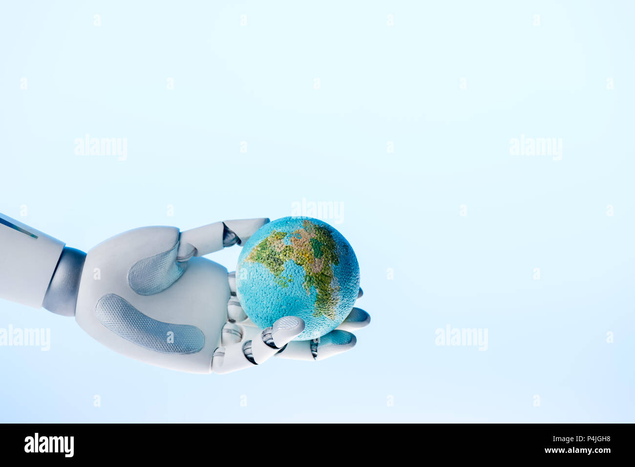 robot hand holding earth model isolated on blue, earth day concept ...