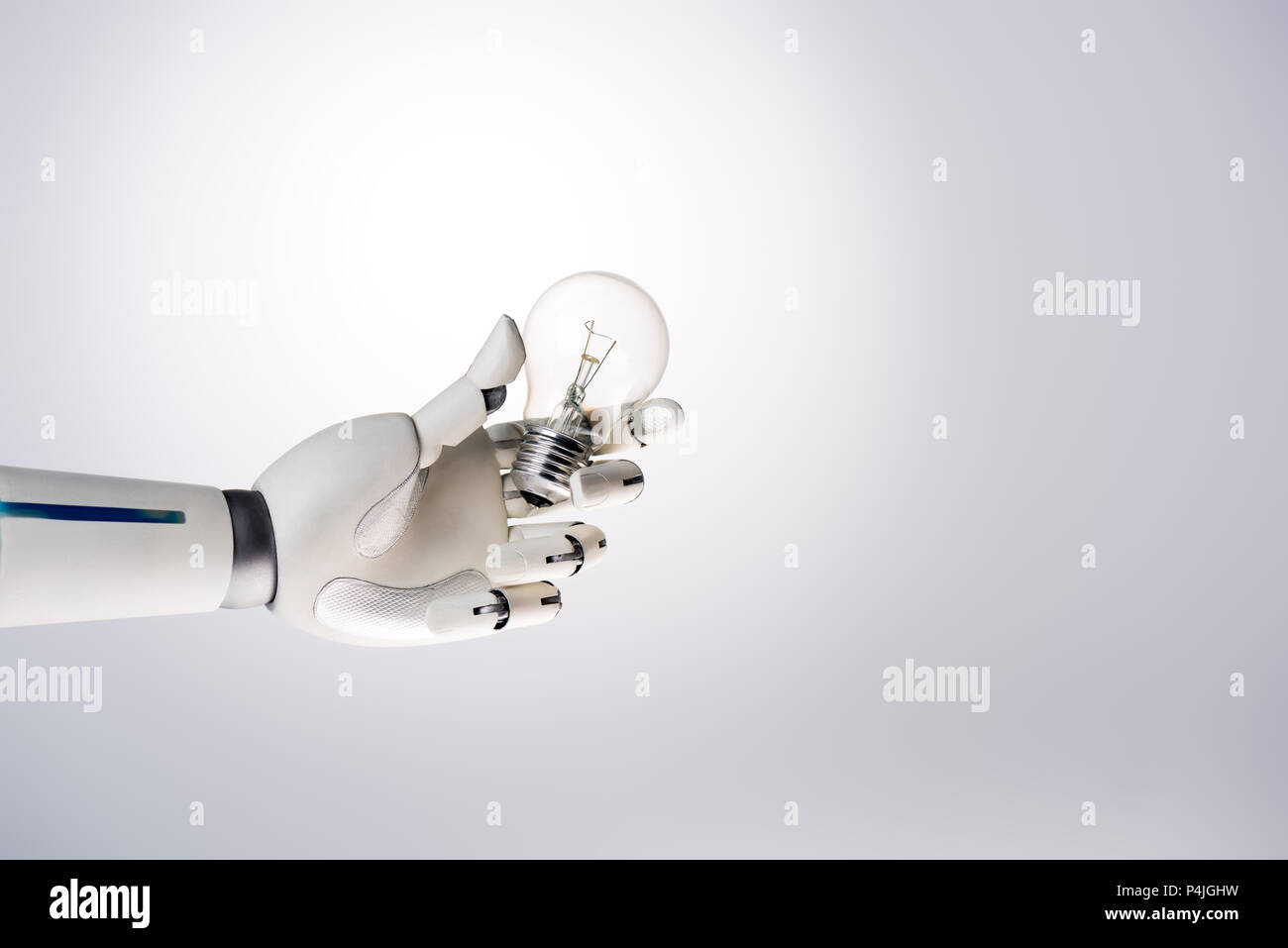 robot hand holding lamp isolated on grey Stock Photo - Alamy
