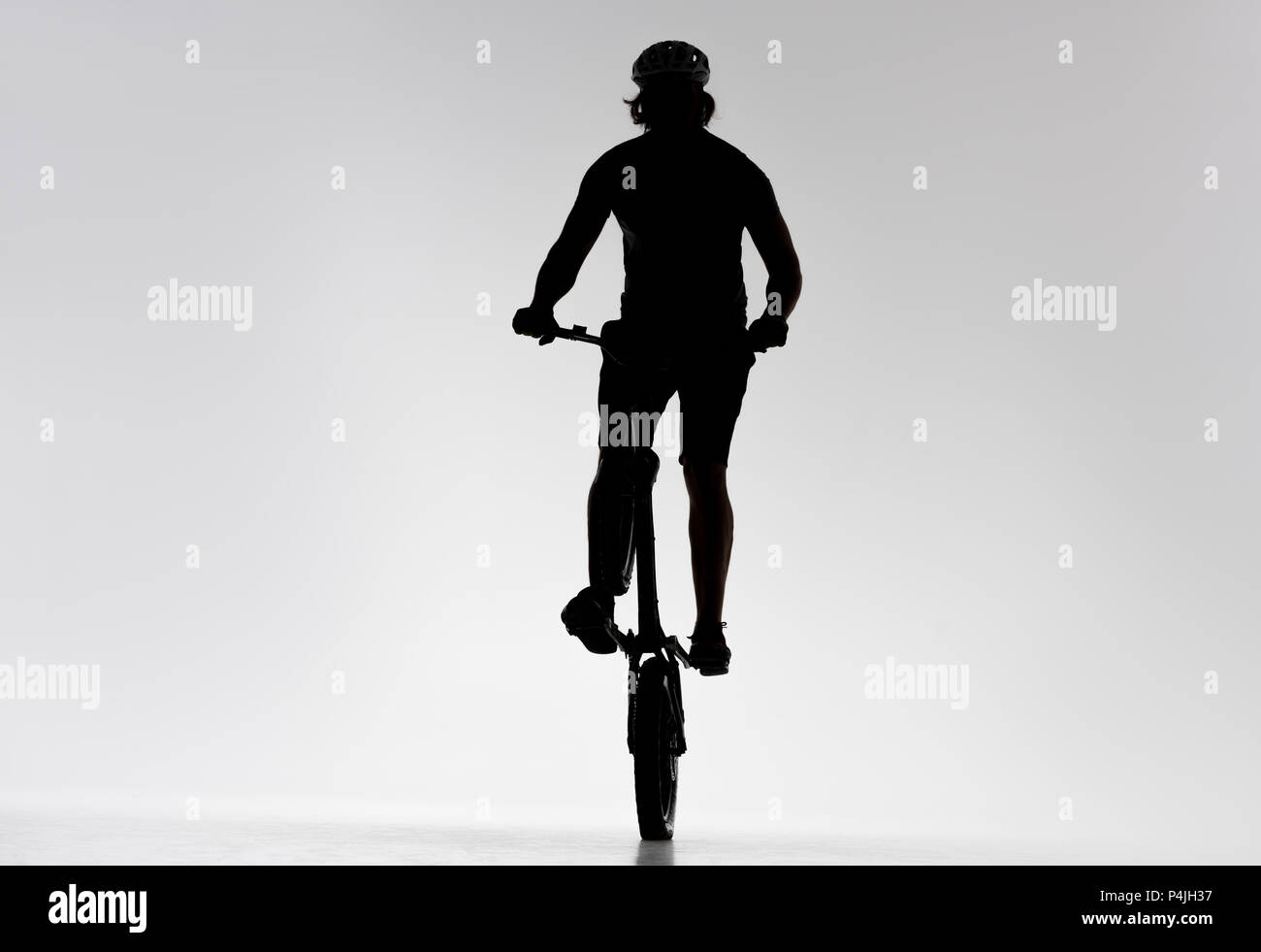 Man riding wheelie on bicycle hi-res stock photography and images - Alamy