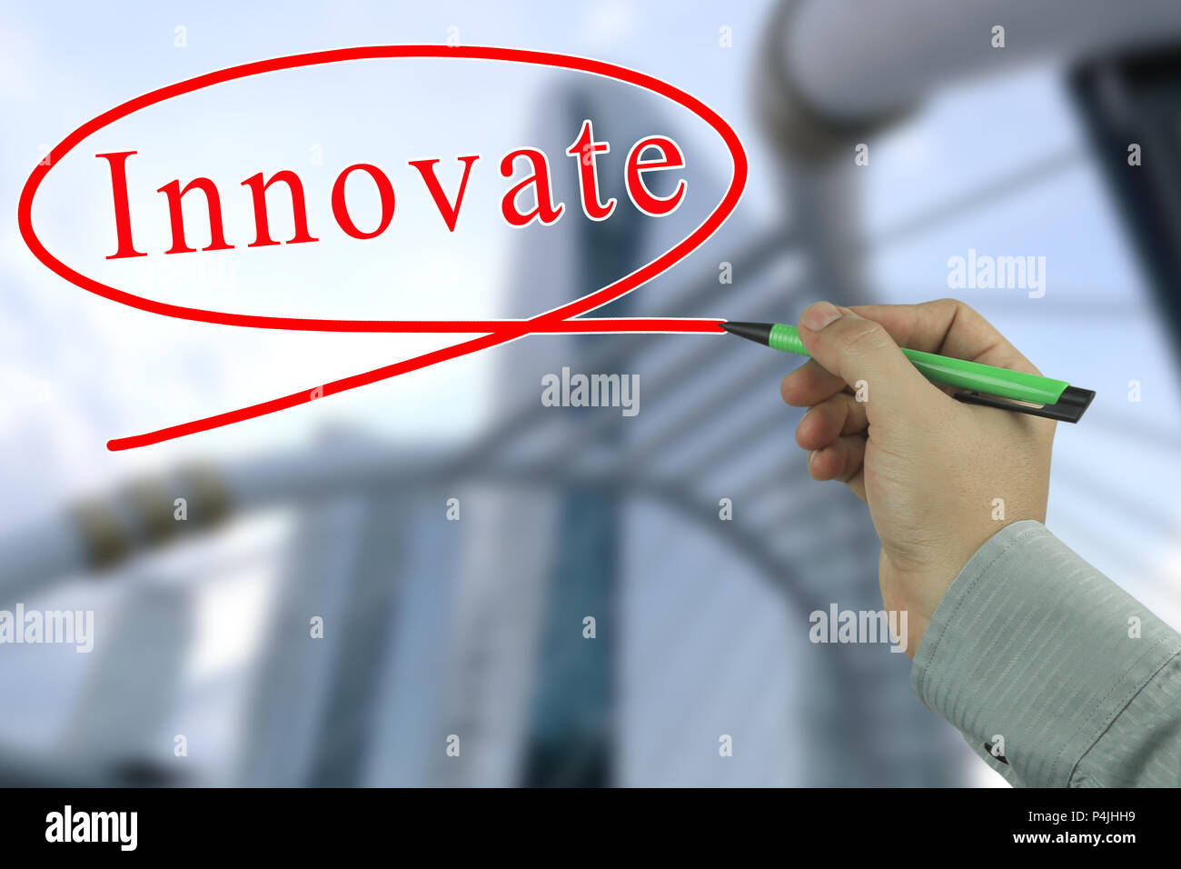 Hand of a businessman holding a green pen writing a innovate text on ...