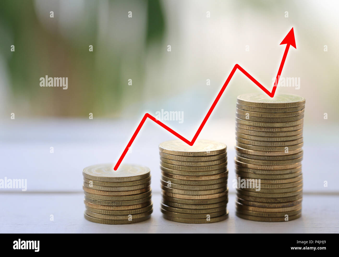 Coin stack on wooden floor and red arrow to grow for design in your ...