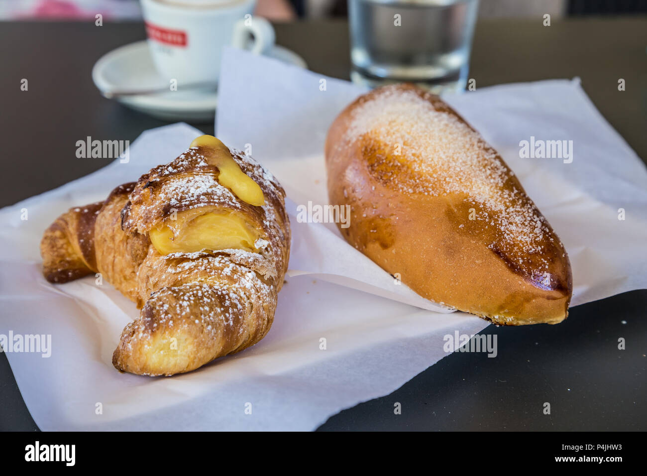 Syracuse in Sicily, Italy. Traditional fresh brioches with cream served ...