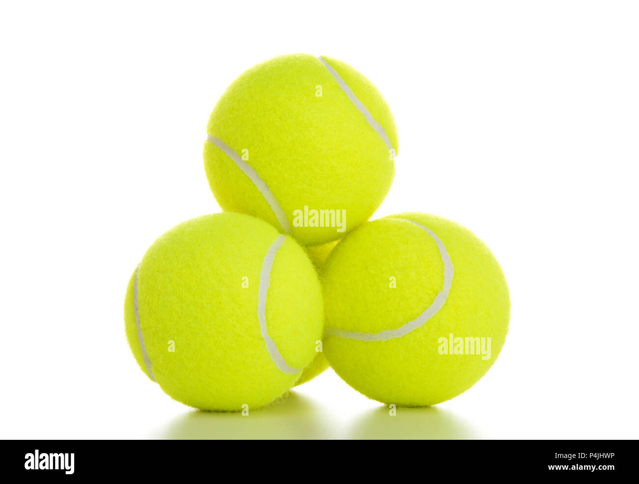 stack of four yellow tennis balls isolated on white background Stock ...