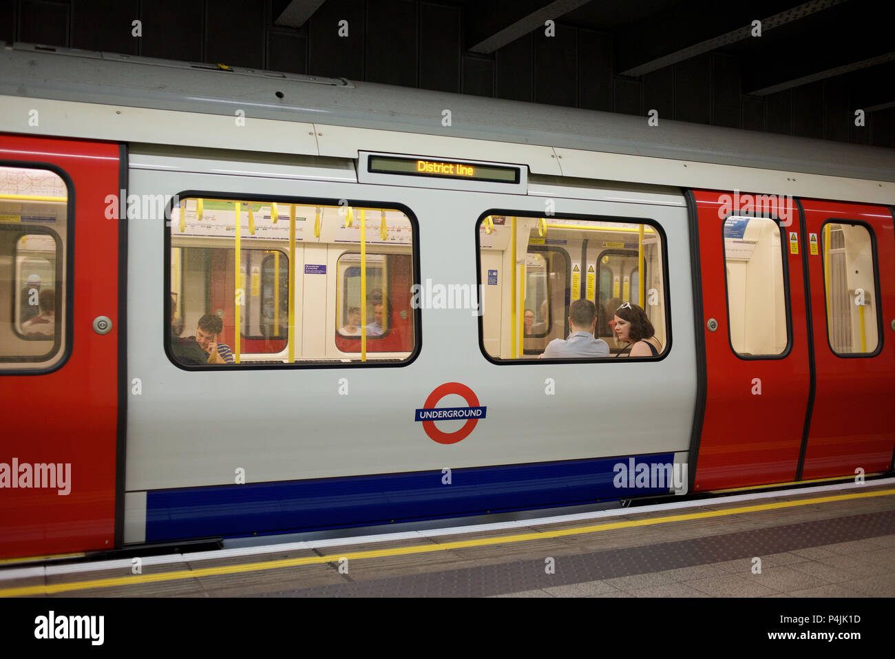 District Line train on the London Underground at Aldgate East station ...