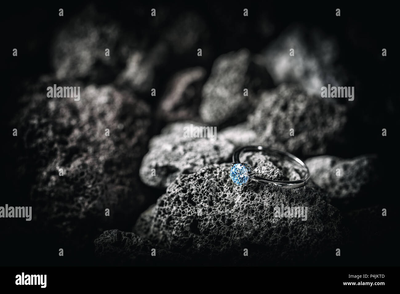 Ring with crystals on dark rock background Stock Photo - Alamy