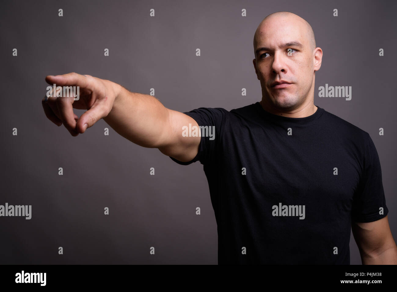 Handsome bald man against gray background Stock Photo - Alamy