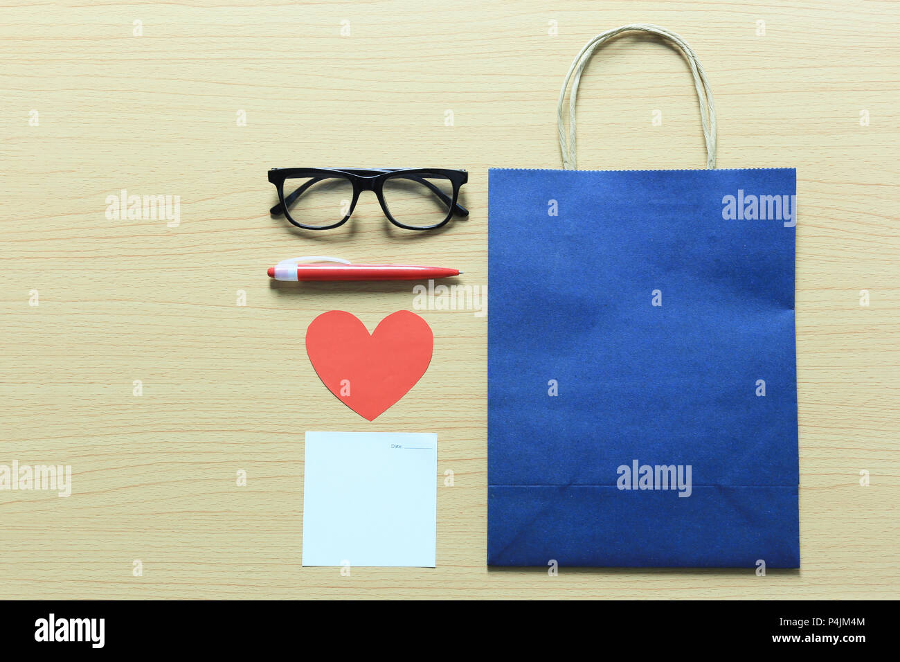 Blue Paper bags and accessories on the wooden floor and have copy space ...