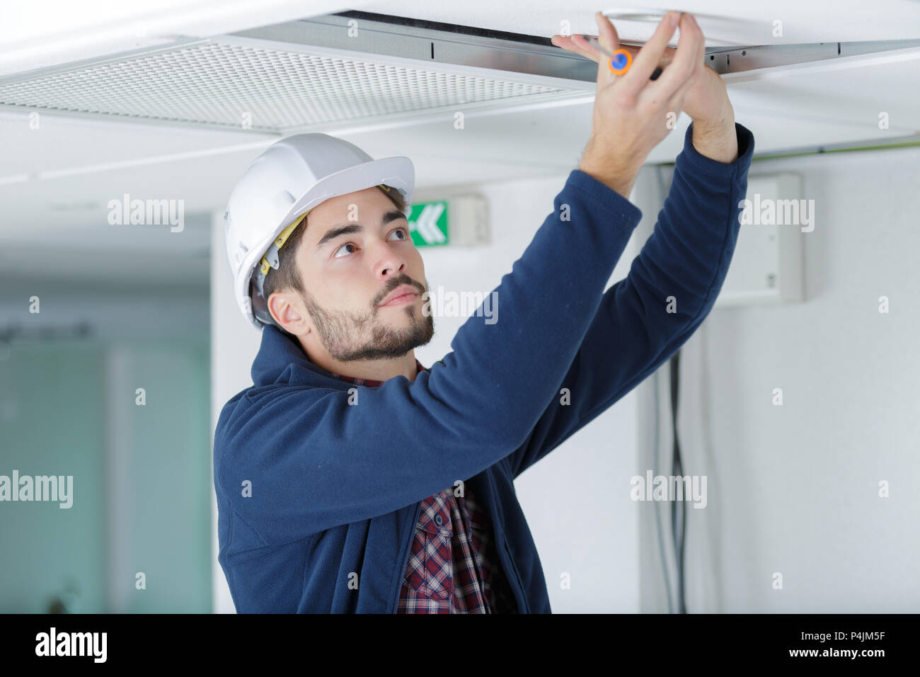contractor unscrewing overhead ceiling panel Stock Photo - Alamy