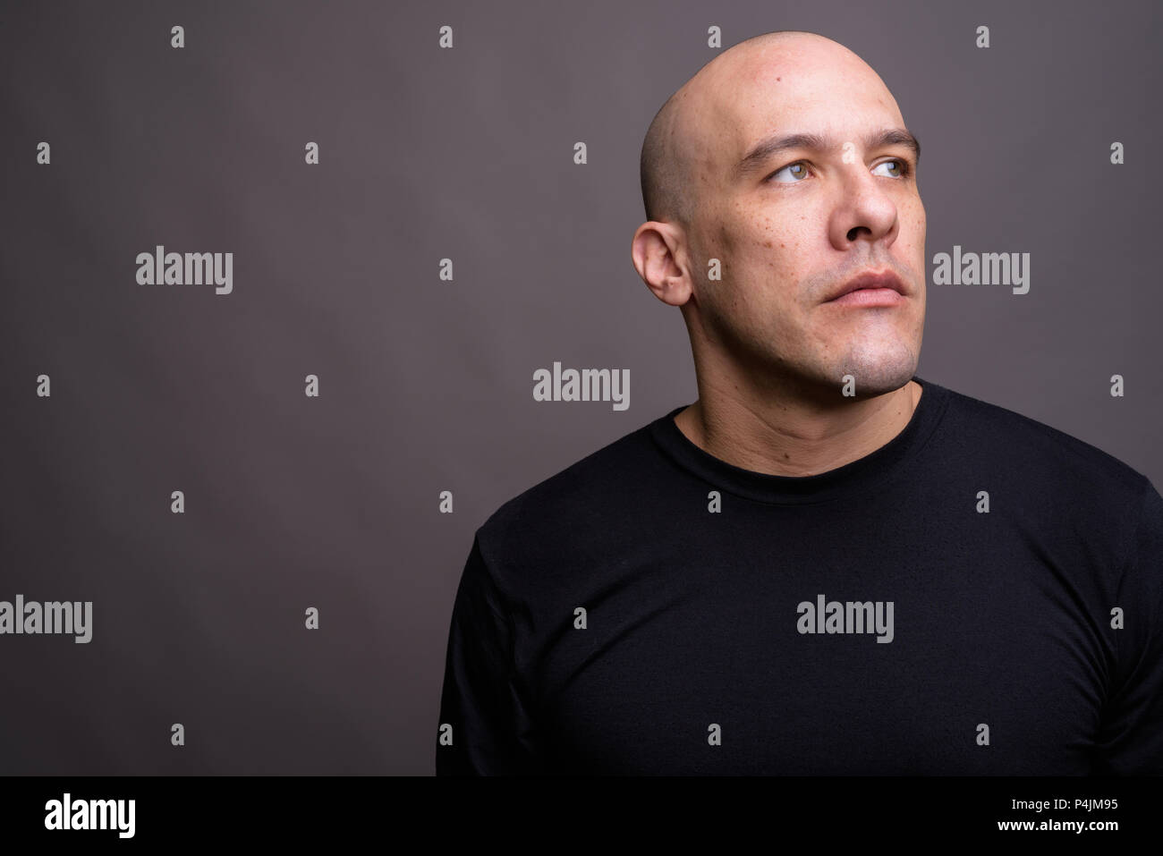 Handsome bald man against gray background Stock Photo - Alamy