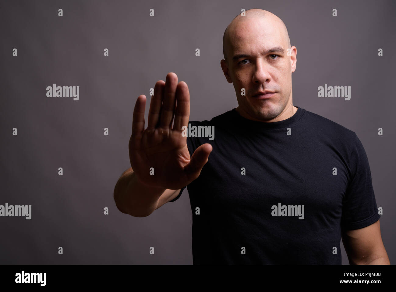 Handsome bald man against gray background Stock Photo - Alamy