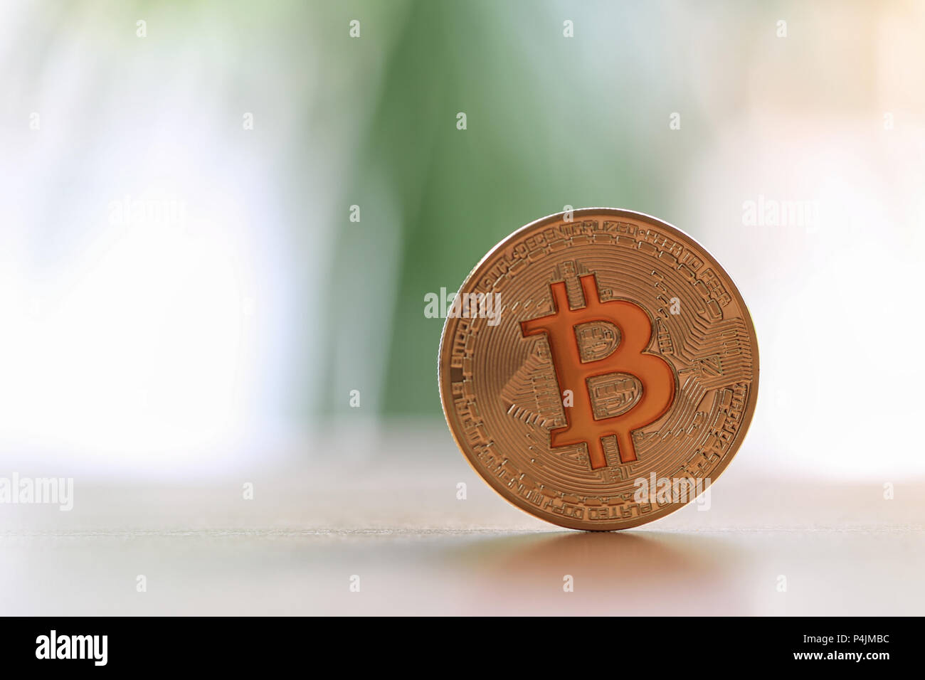 Golden Medal of bitcoin on wooden floor and have copy space for design ...