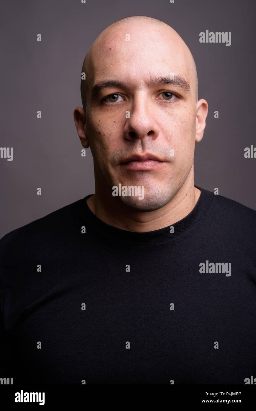 Handsome bald man against gray background Stock Photo - Alamy