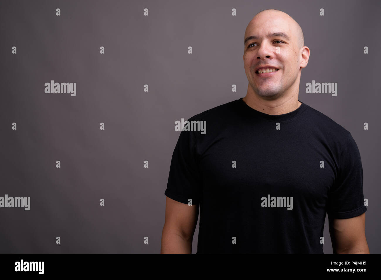 Handsome bald man against gray background Stock Photo - Alamy