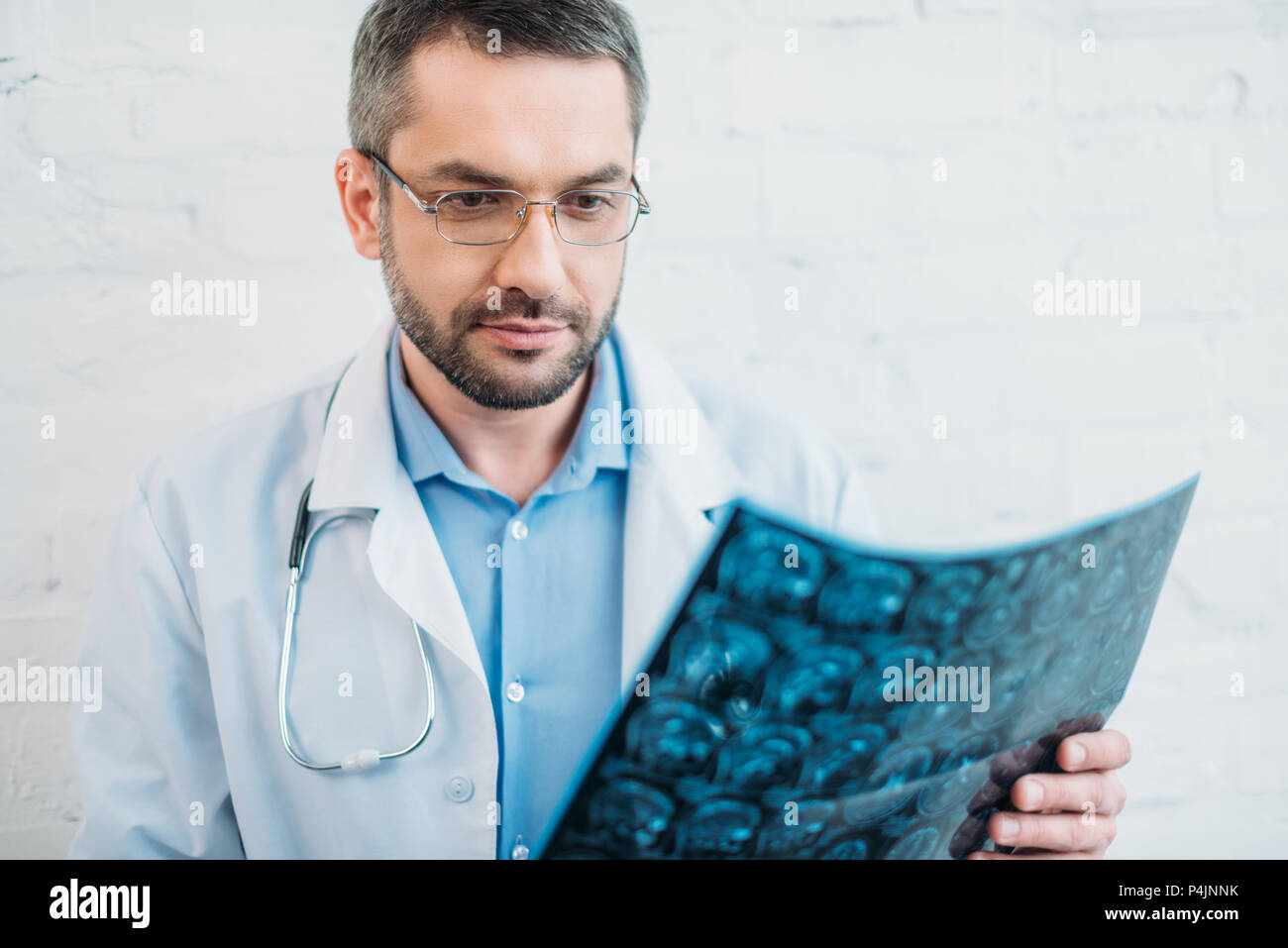 handsome adult doctor examining mri scan Stock Photo - Alamy