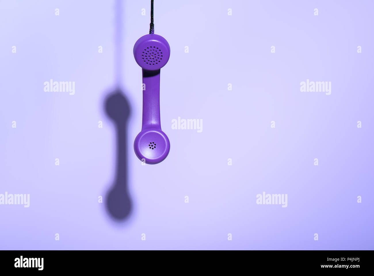 hanging purple telephone handset, ultra violet trend Stock Photo - Alamy
