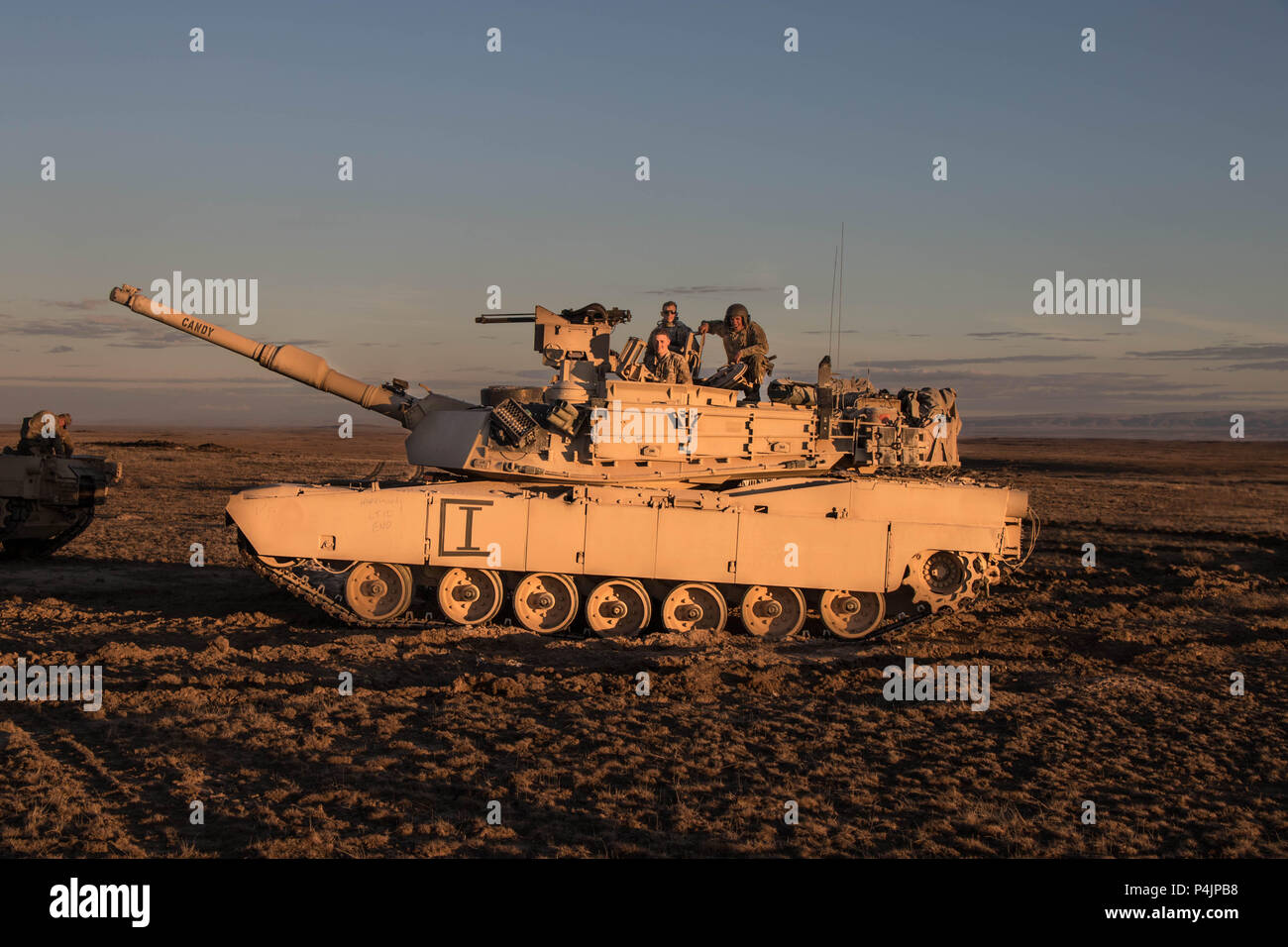 An M1 Abrams team poses ontop of their tank prior to the start of a ...