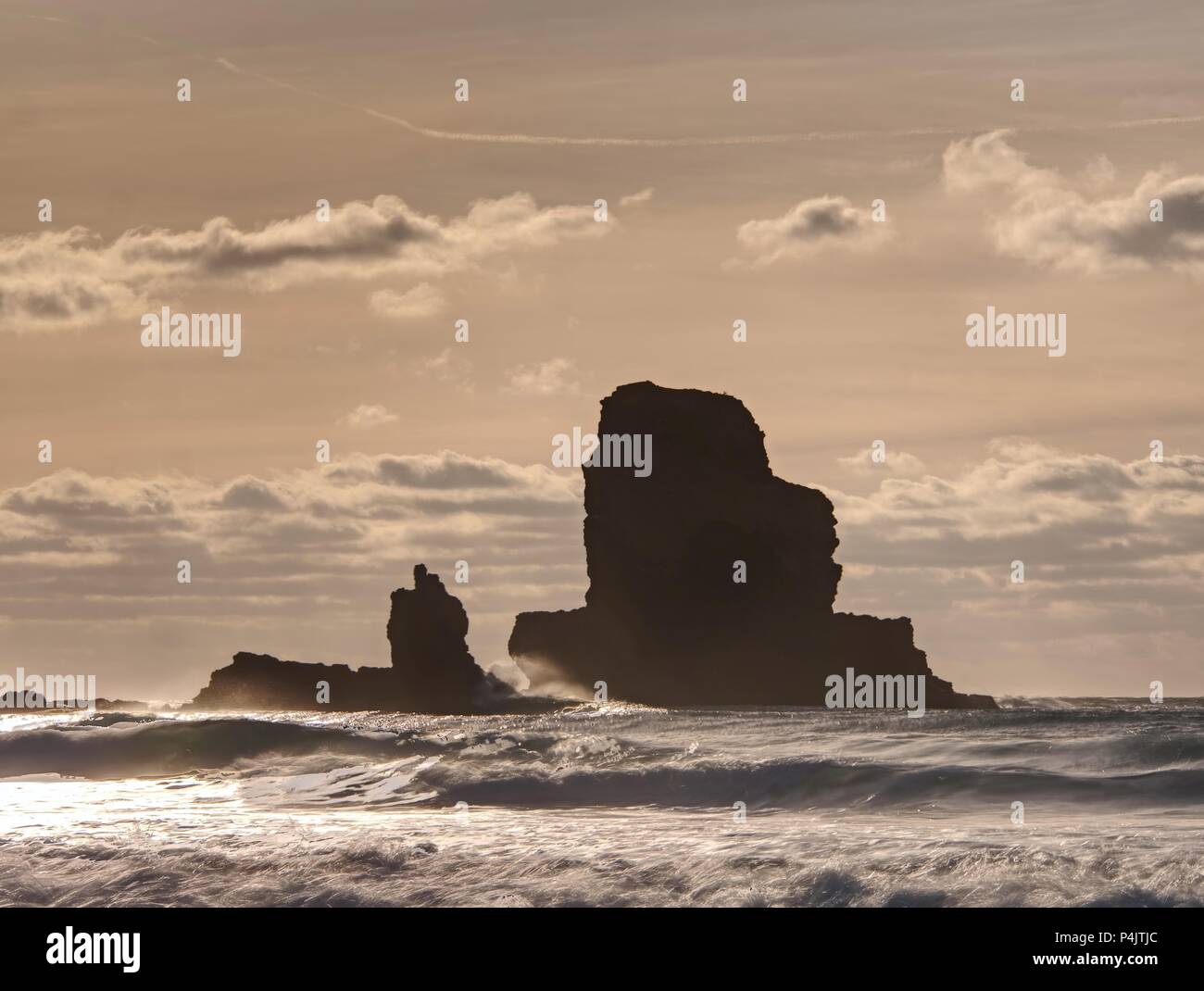 Evening Bay. Sharp rocks, black rounded boulders, stony beach, sand and ...