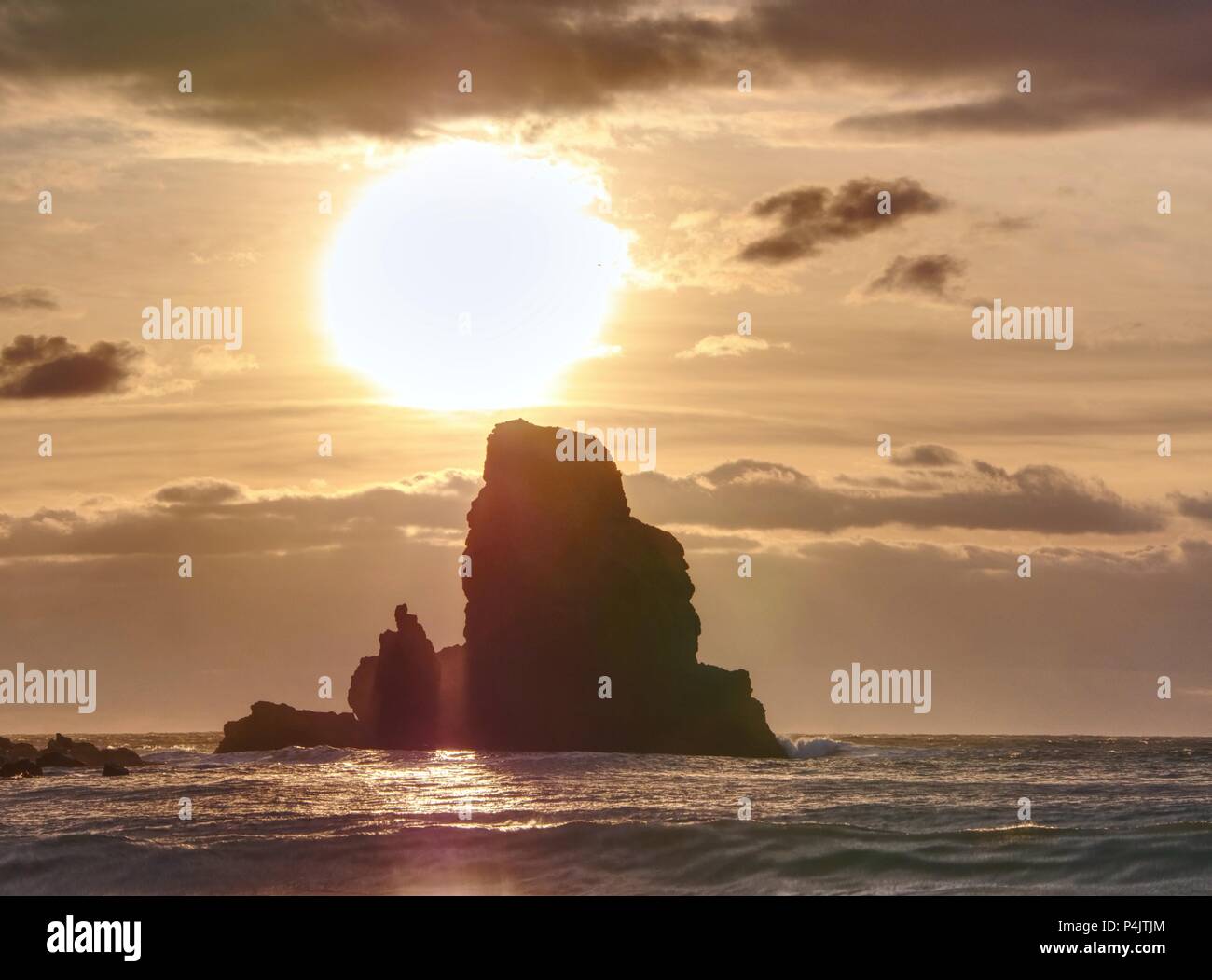 Evening Bay. Sharp rocks, black rounded boulders, stony beach, sand and ...