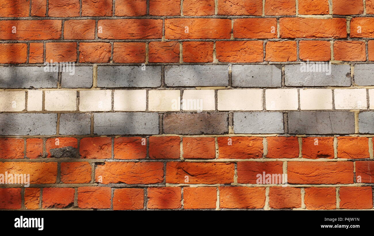 Horizontal stripe of black and white bricks in a red brick wall Stock ...