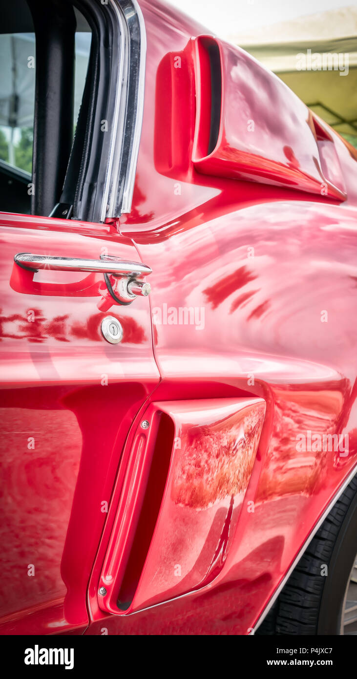 The side air scoops of a sixties American sports car in red Stock Photo ...