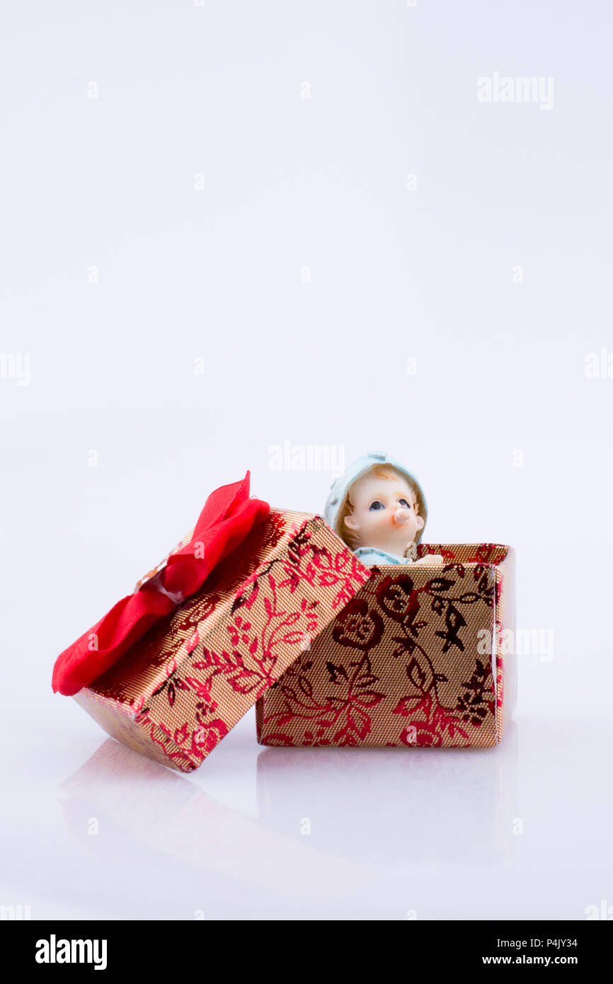 Little baby figure in a gift box Stock Photo - Alamy