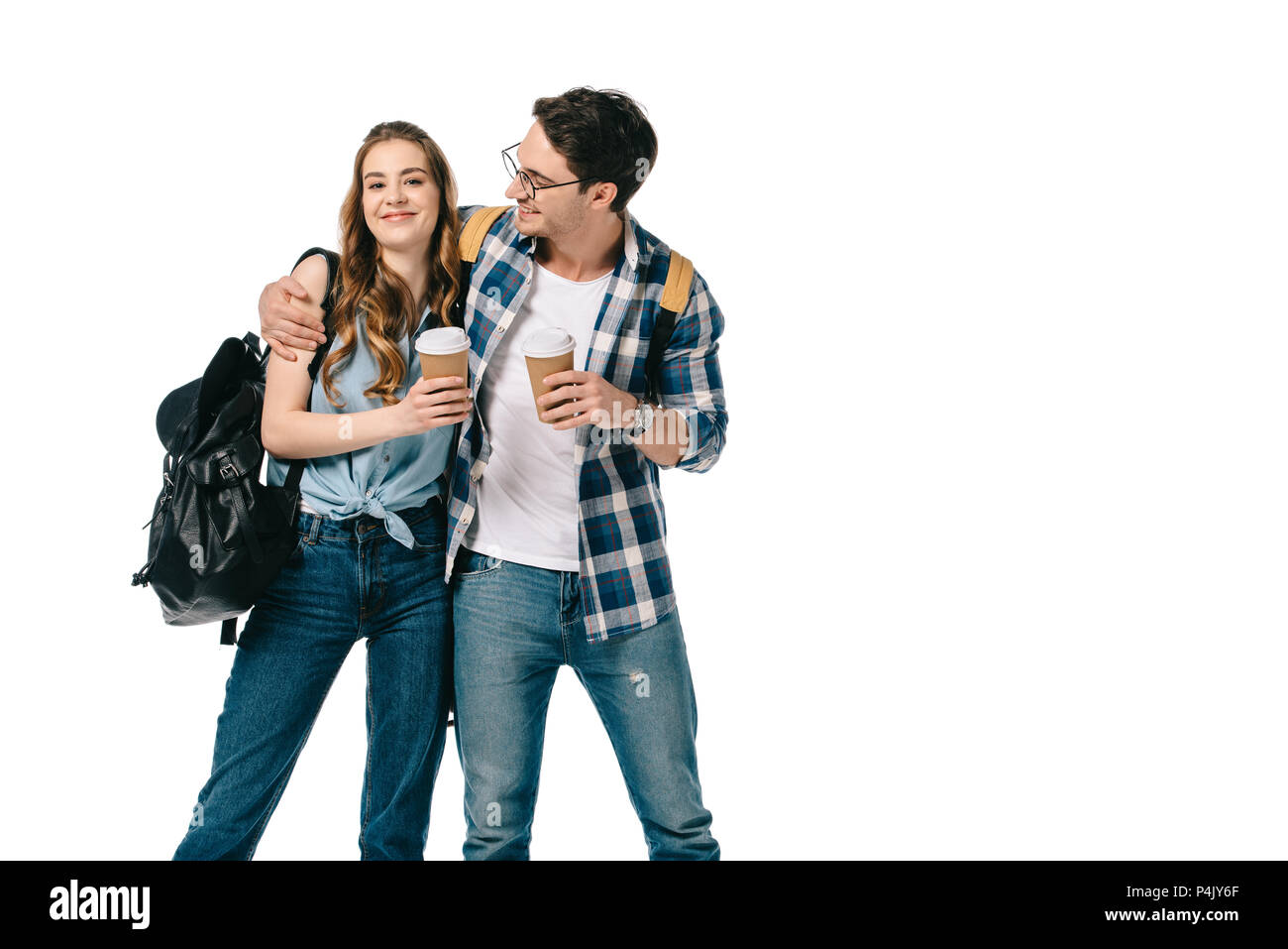 young students hugging and holding disposable coffee cups isolated on ...