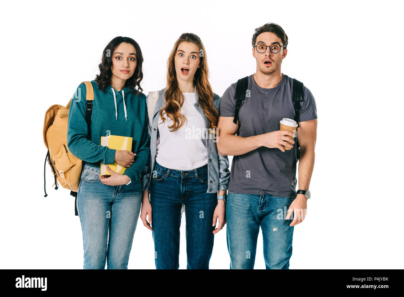 shocked multicultural students looking at camera isolated on white ...