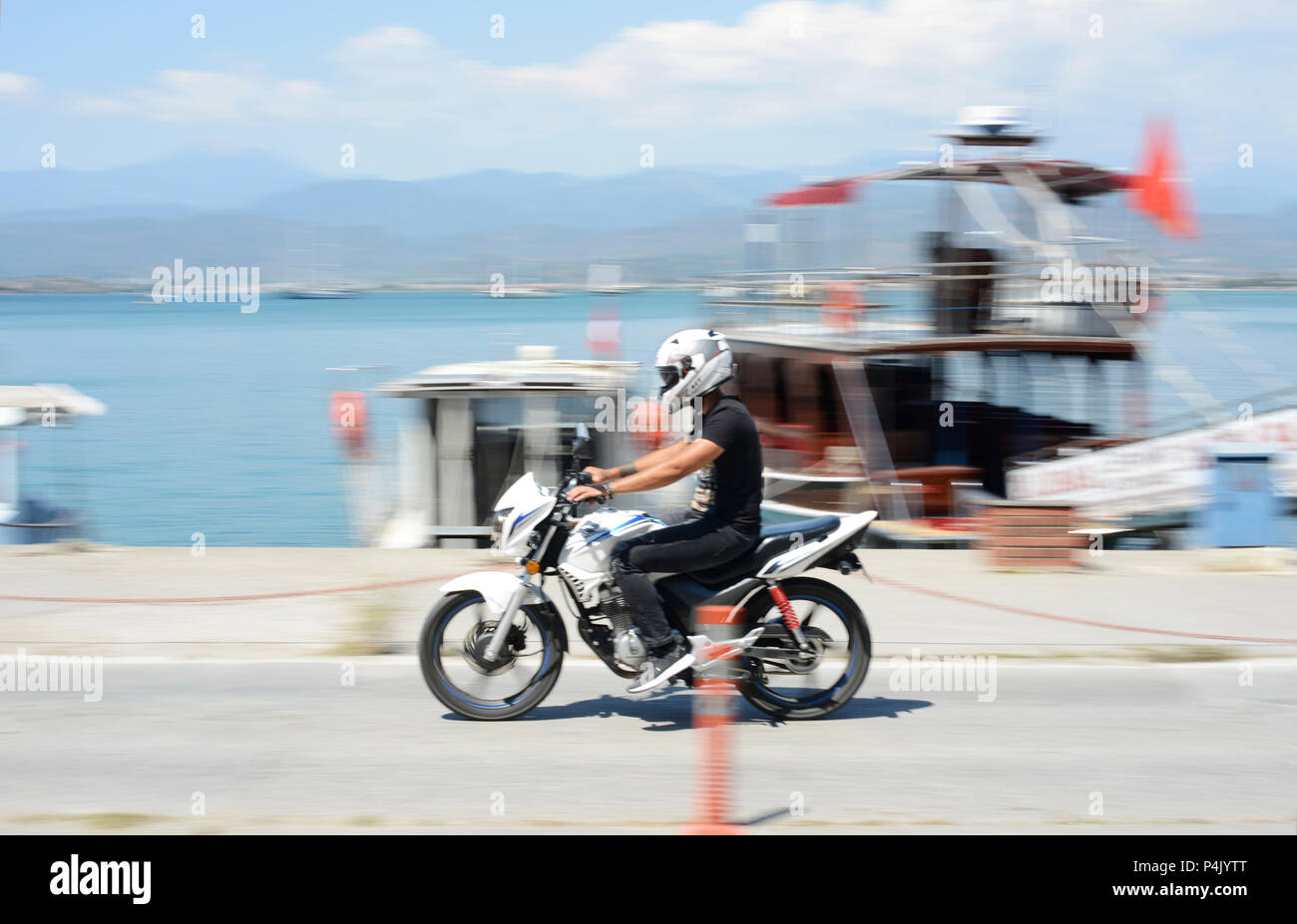 Speeding Scooters on Fetihye harbour Stock Photo - Alamy