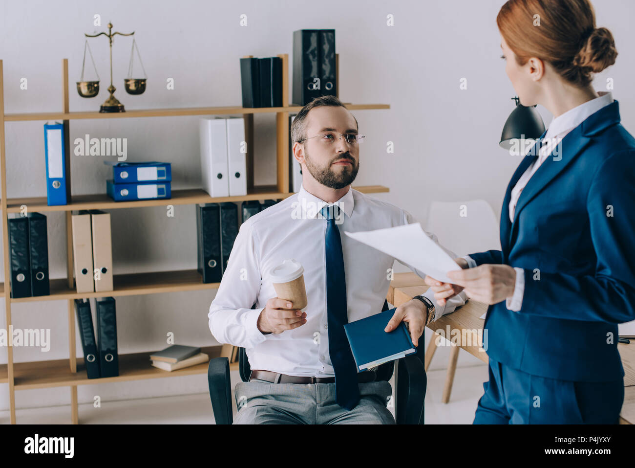 lawyers discussing work together at workplace in office Stock Photo - Alamy
