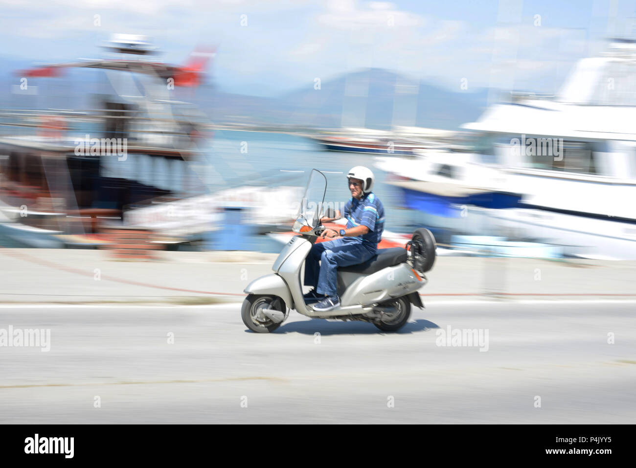 Speeding Scooters on Fetihye harbour Stock Photo - Alamy