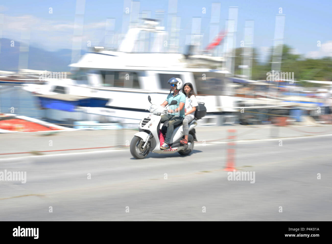 Speeding Scooters on Fetihye harbour Stock Photo - Alamy