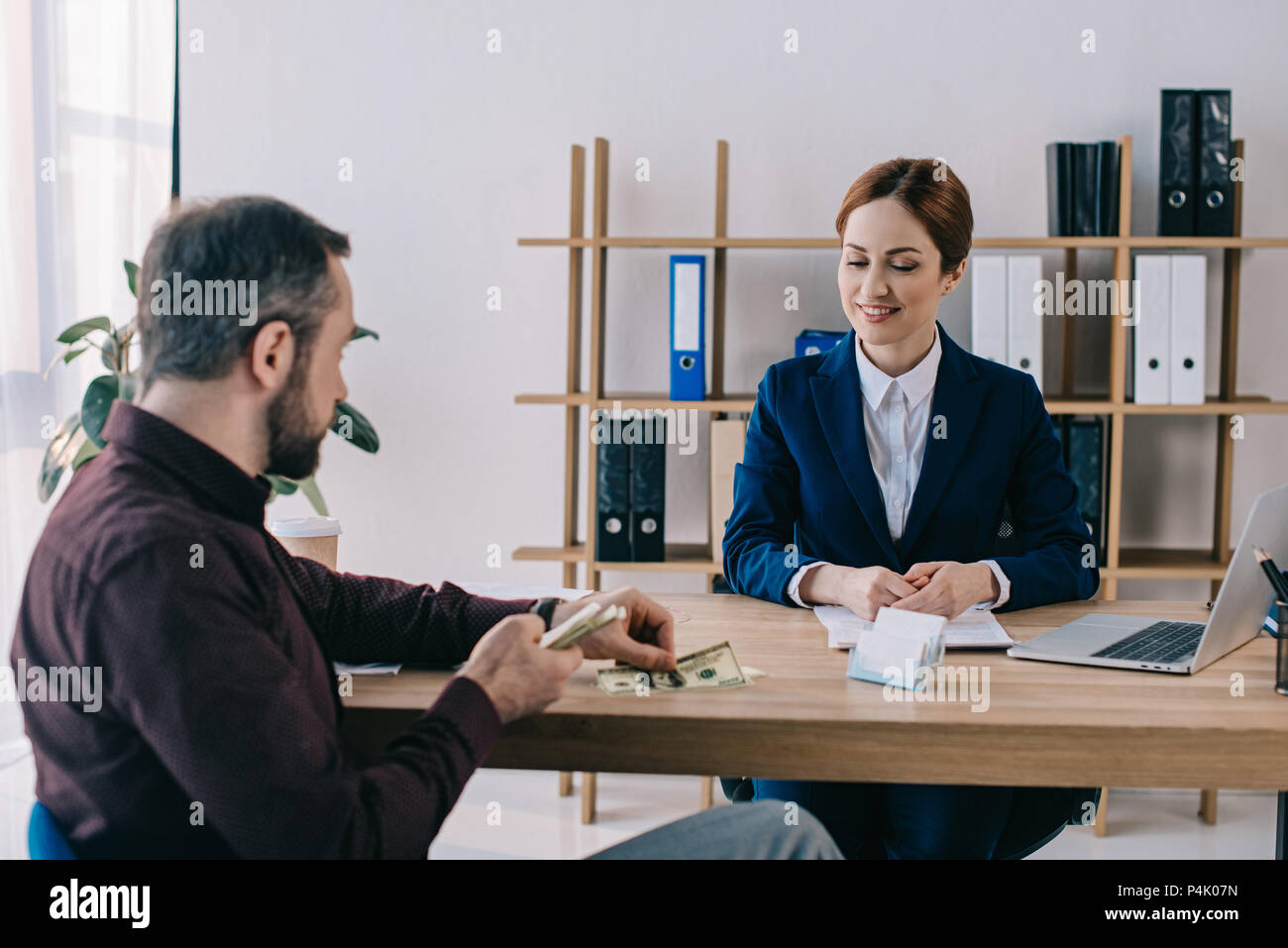 man giving bribe to businesswoman at workplace in office Stock Photo ...