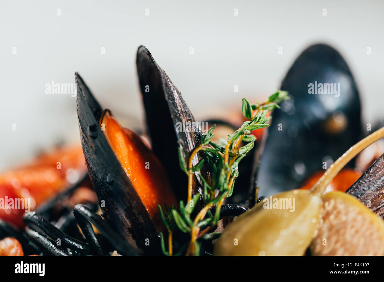 delicious dish with spaghetti with cuttlefish ink, squid and mussels ...