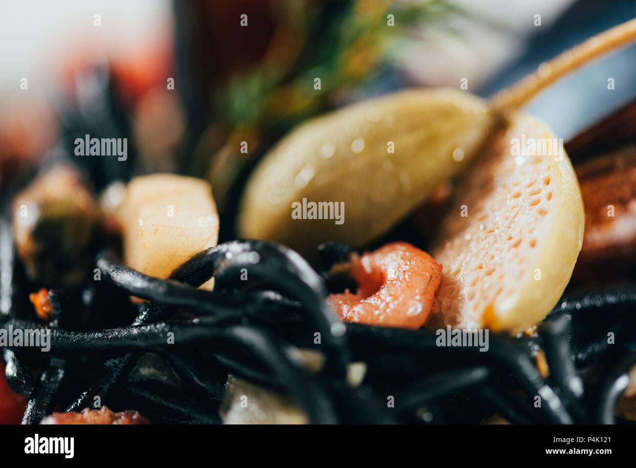close-up view of gourmet spaghetti with cuttlefish ink, squid and ...