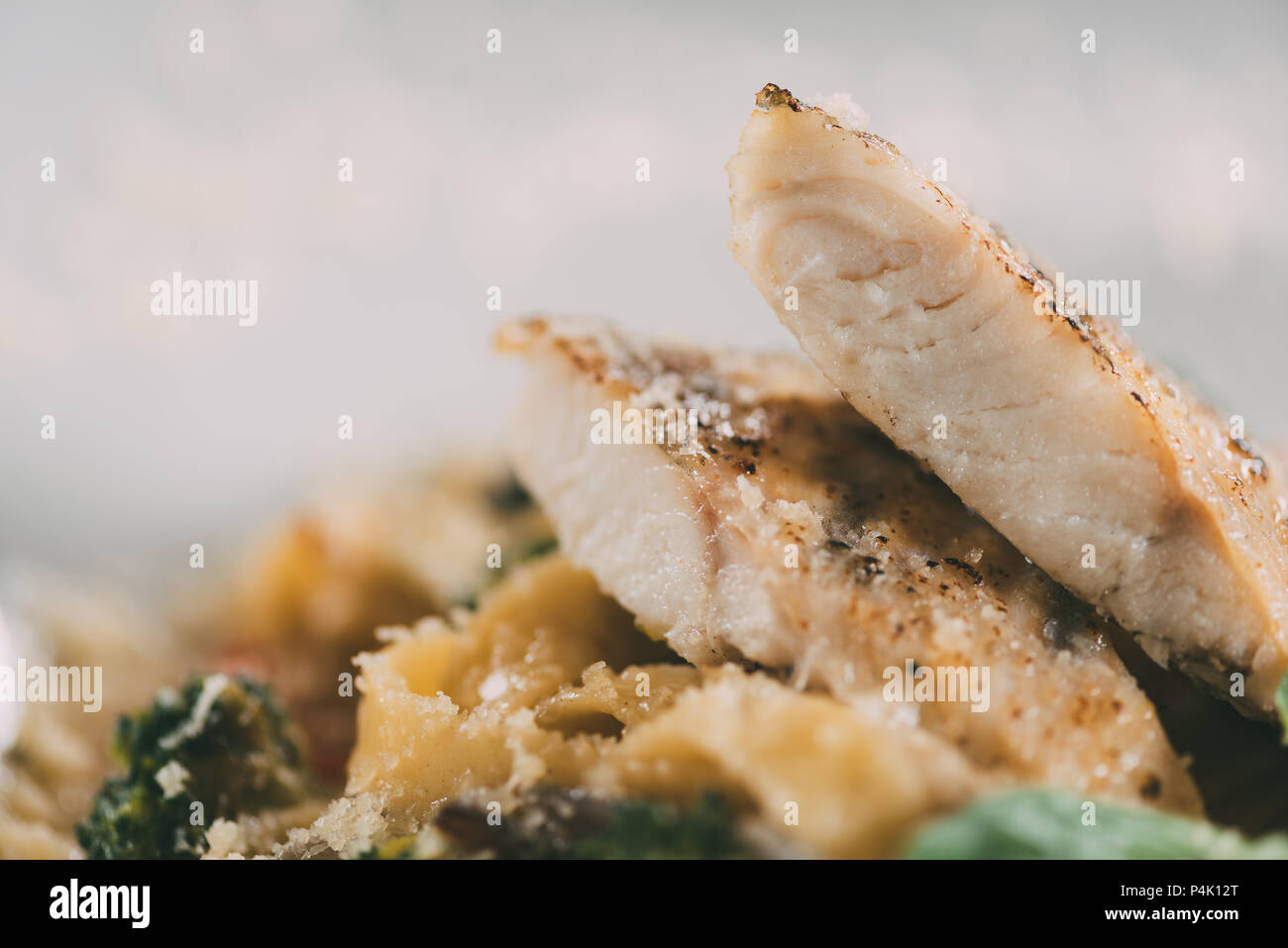 close-up view of delicious pasta with pike perch fillet and parmesan ...