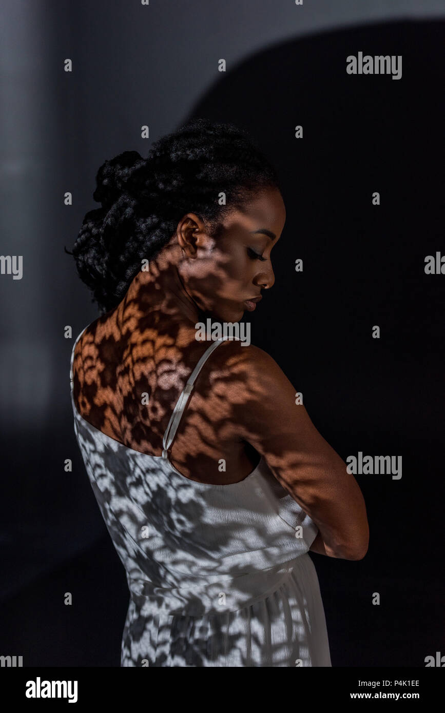 rear view of young african american woman with shadow on back Stock ...