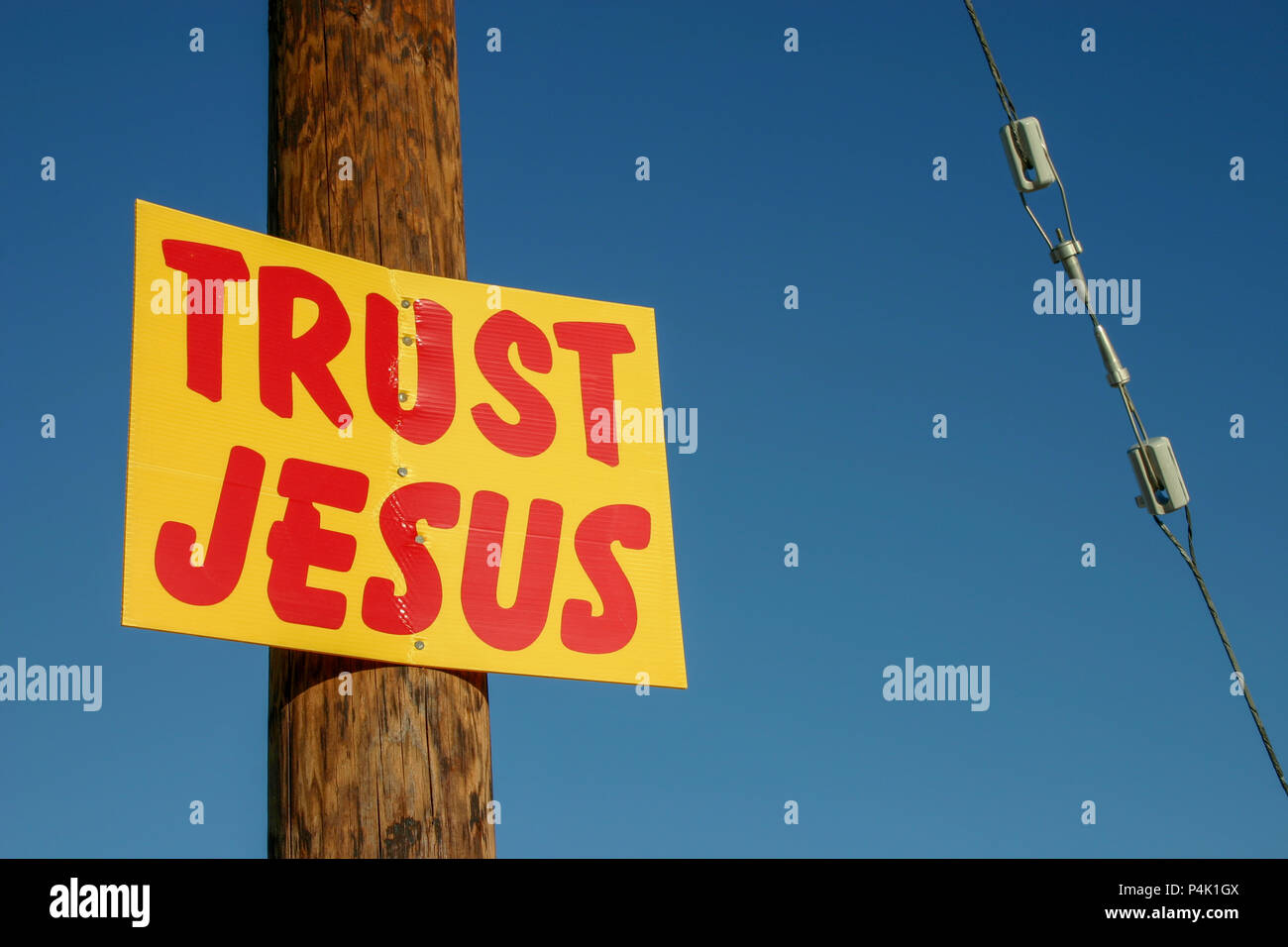 Trust Jesus, roadside sign stapled to high desert roadside phone pole ...