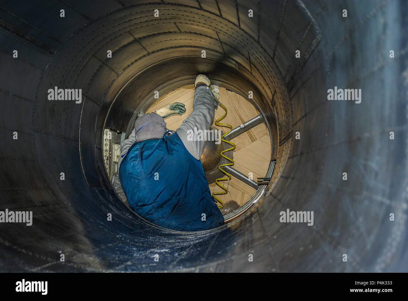 A volunteer working on the engine of a preserved ex RAF Cold War Avro ...